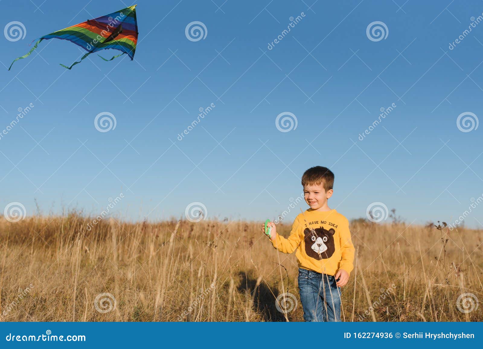 Little Boy with Kite Flying Over His Head Stock Photo - Image of ...