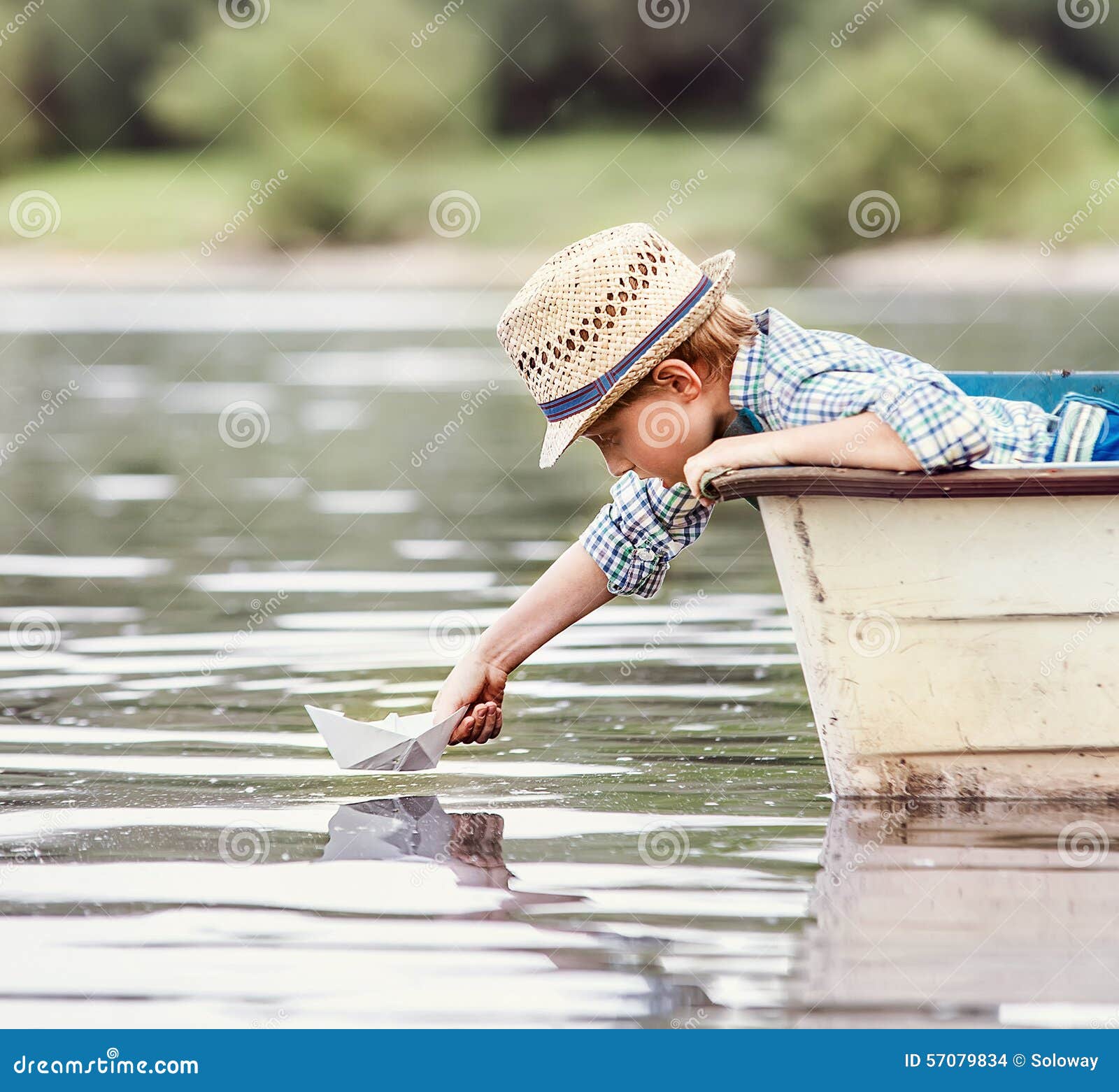 Little Boy Launch Paper Ship From Old Boat On The Lake Royalty-Free ...