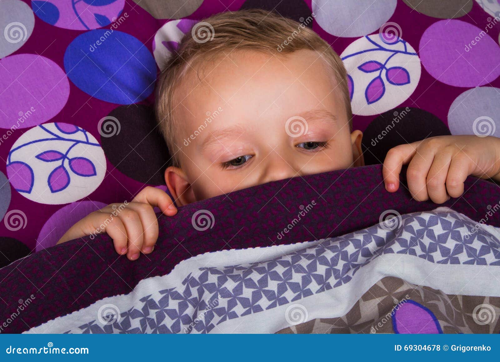 Little boy lay on the bed stock photo. Image of person - 69304678