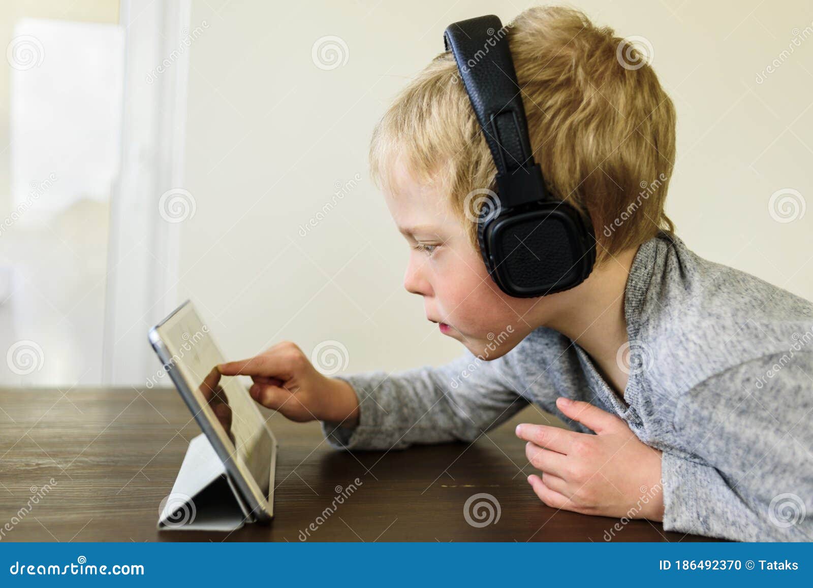 Little Boy Learning at Home. Watching Webinar on Mobile Tablet Stock ...