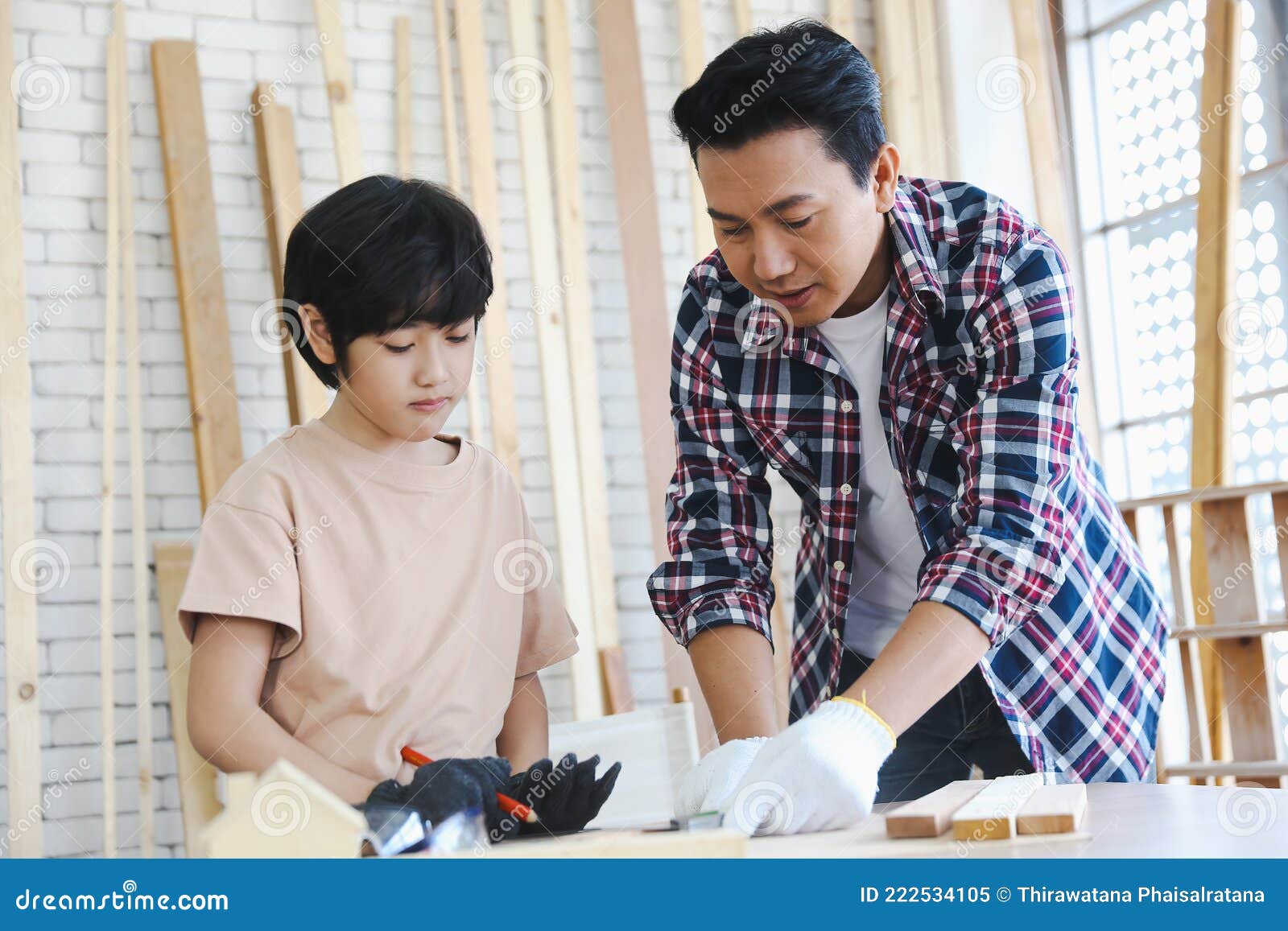 Little Boy is Learning To Work on Wood. Father and Son are Working on ...