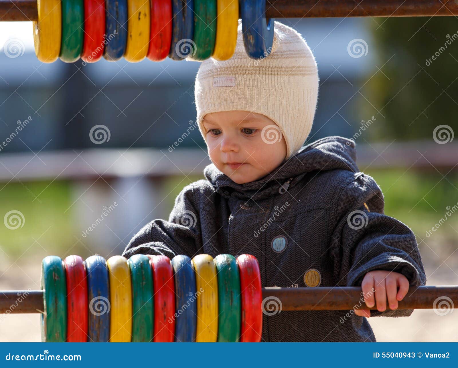 Little Boy Learns Colors by Using Colored Rings on the Playground Stock ...