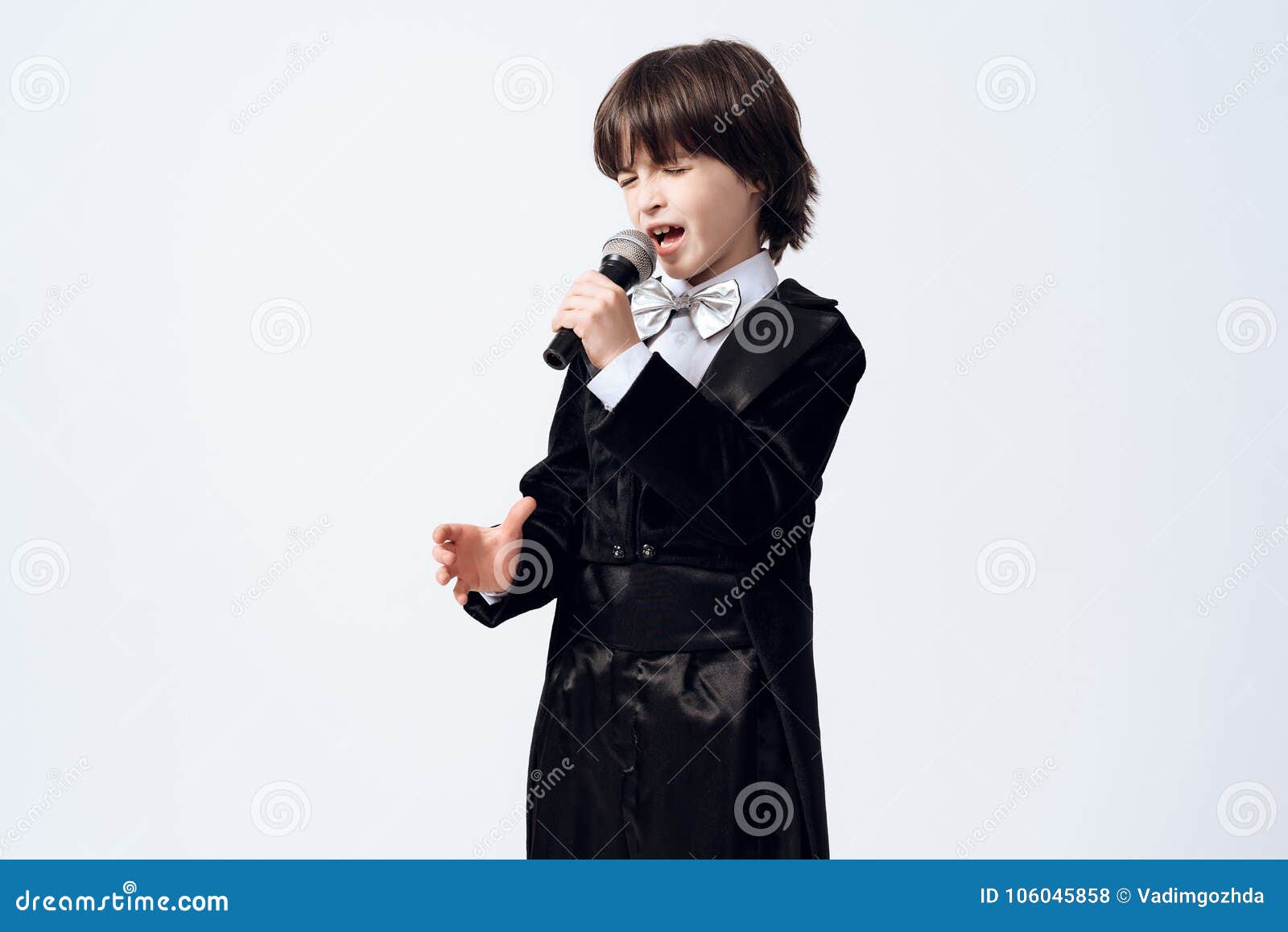 A Little Boy Learns Profession of a Singer. the Dark-haired Boy in Suit ...