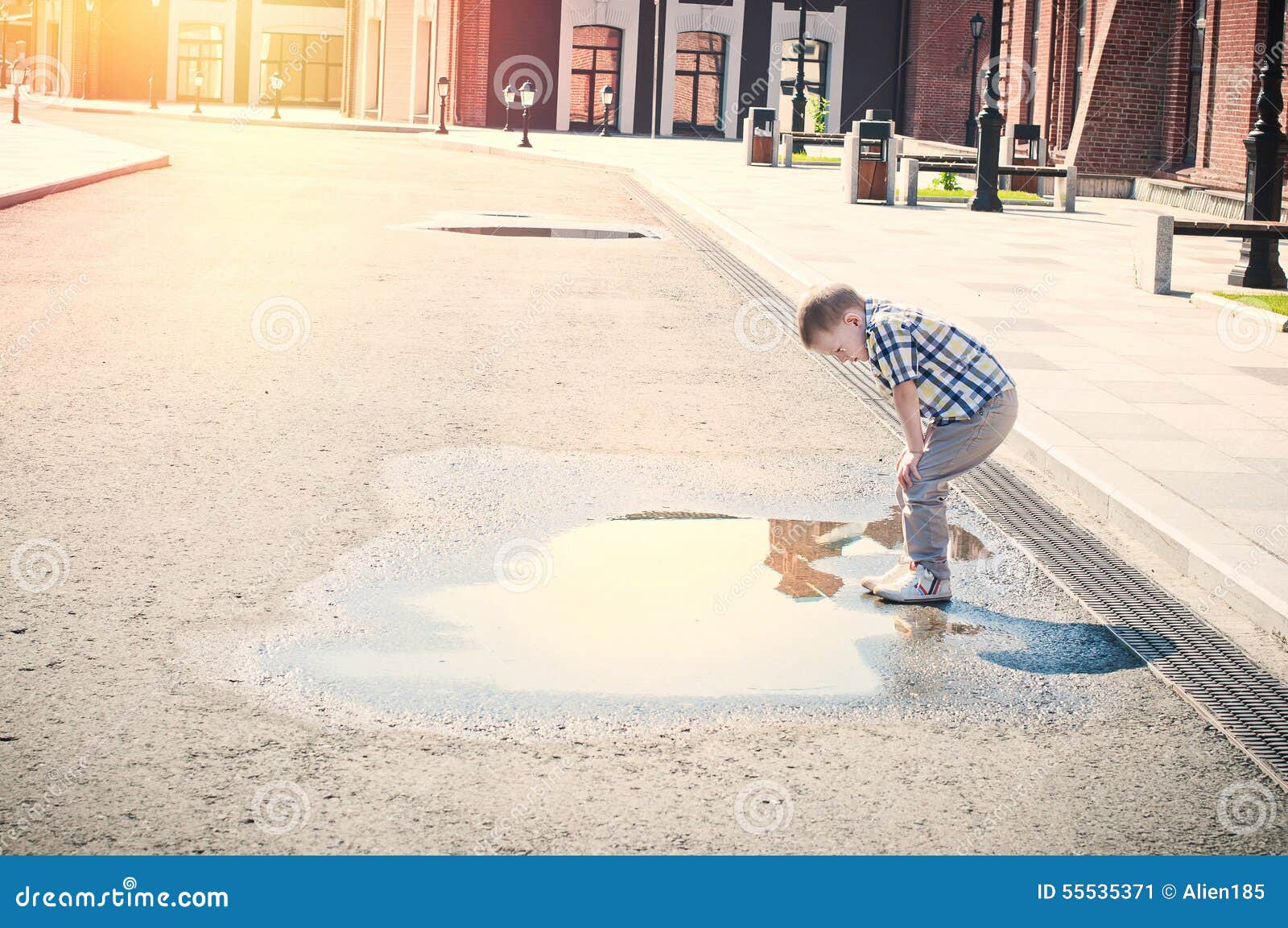 Little Boy is Looking at the Puddle Stock Image - Image of pool ...