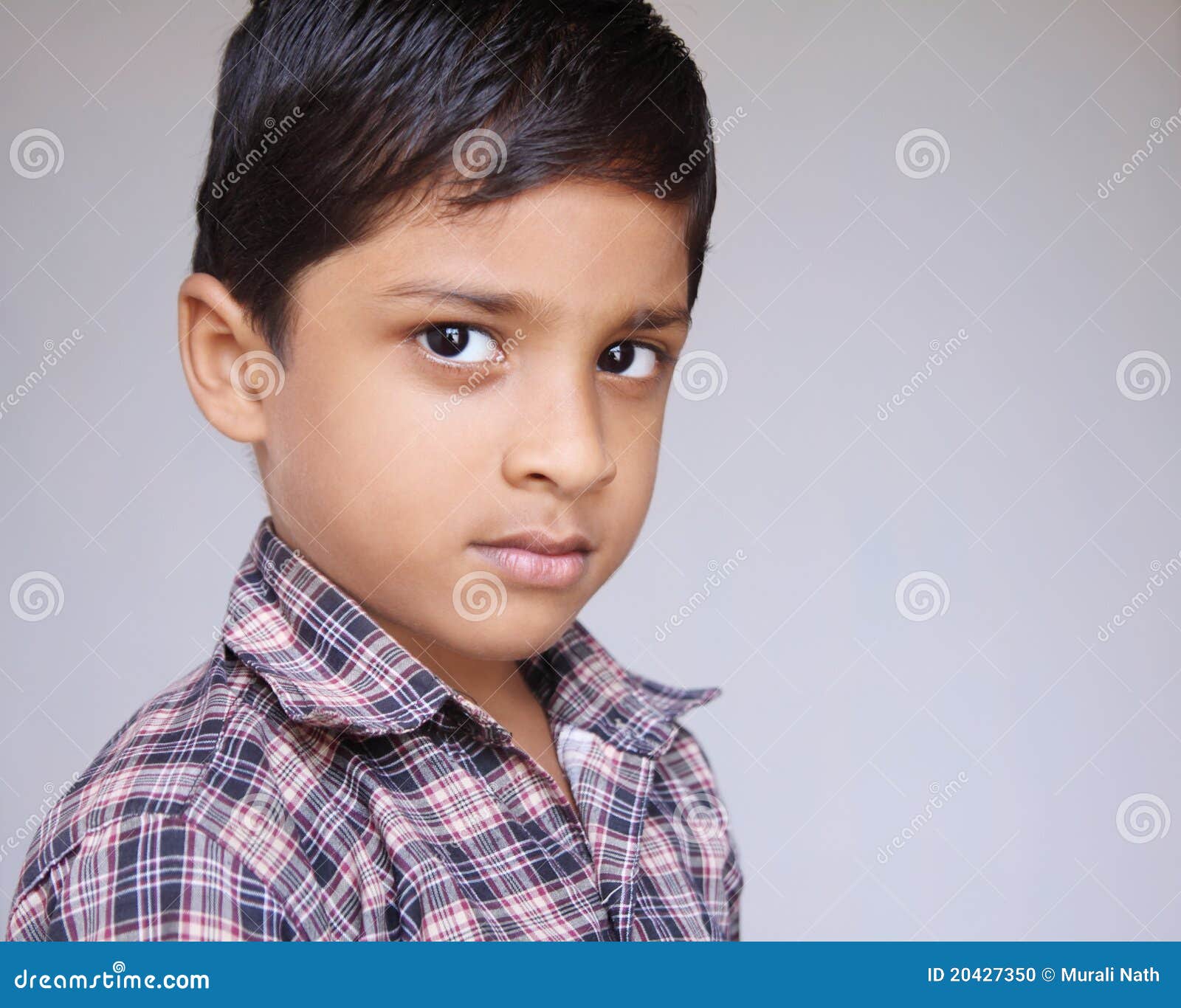 Little Boy Looking Serious stock photo. Image of innocence - 20427350