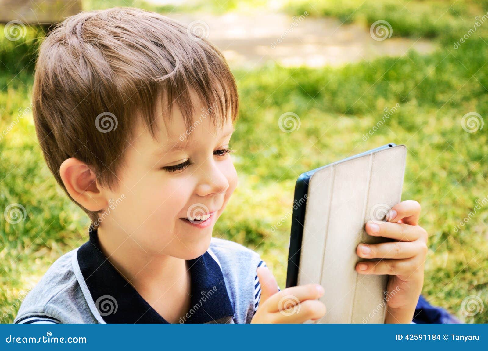 Little Boy Looking at Tablet Outdoor Stock Photo - Image of head ...