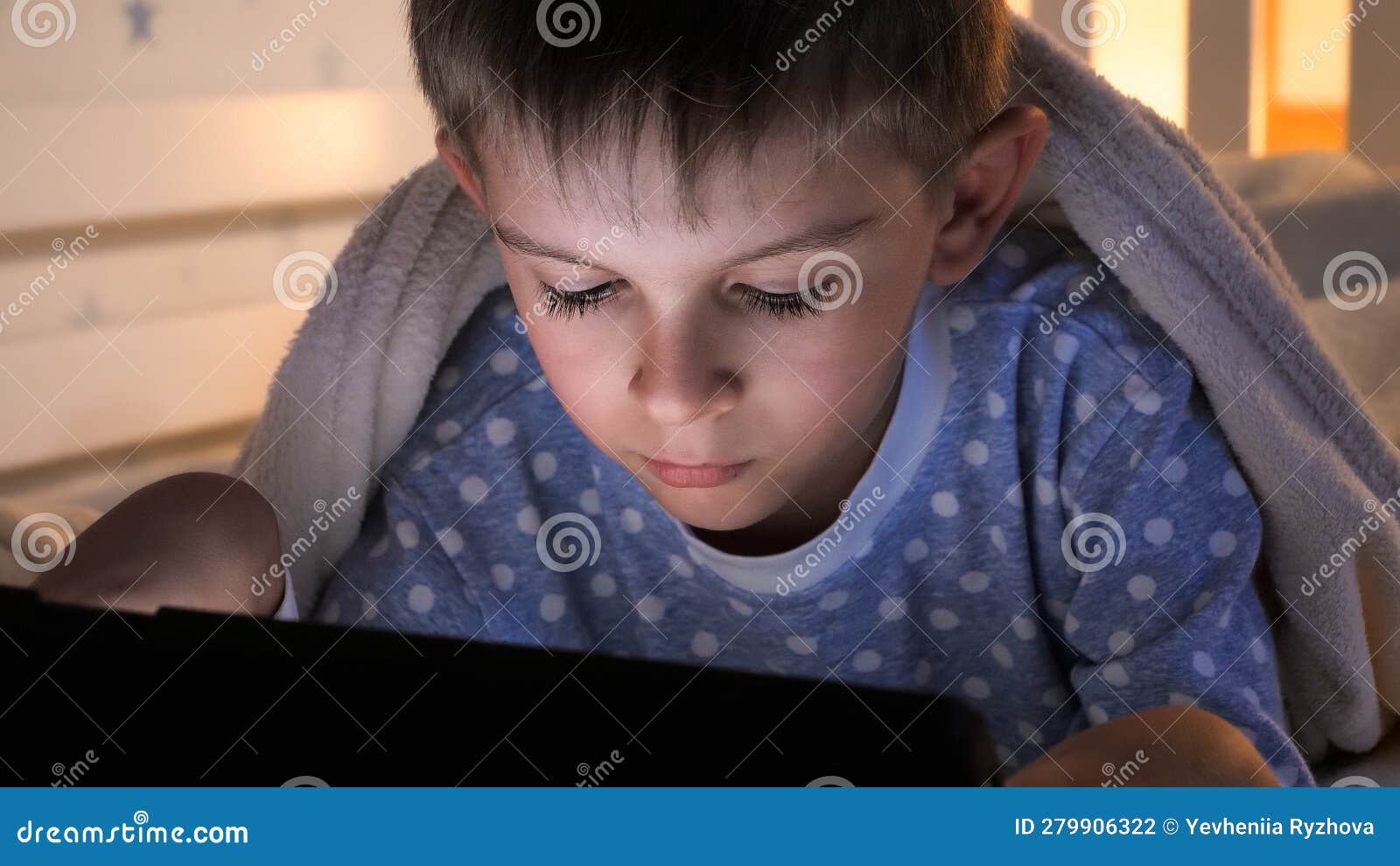 Little Boy Lying in Bed with Tablet Computer and Watching Video ...