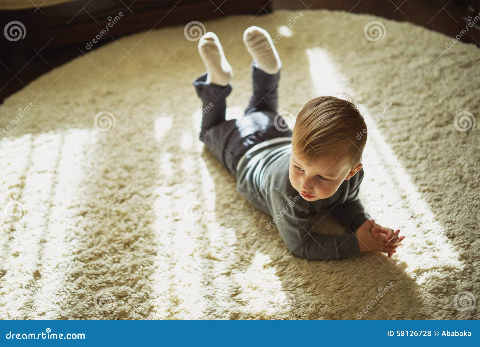 Little Boy Lying on the Carpet Stock Photo - Image of sunny, closeup ...