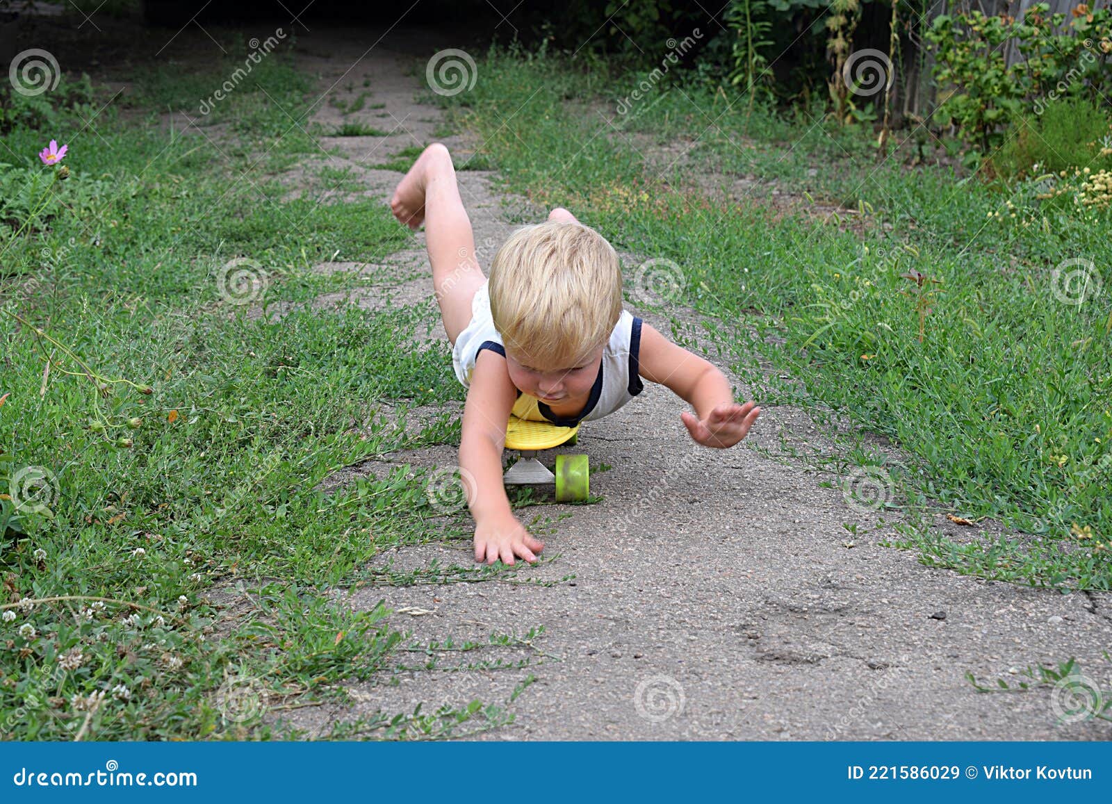 A Small Child is Riding a Skateboard Lying Down Stock Image - Image of ...