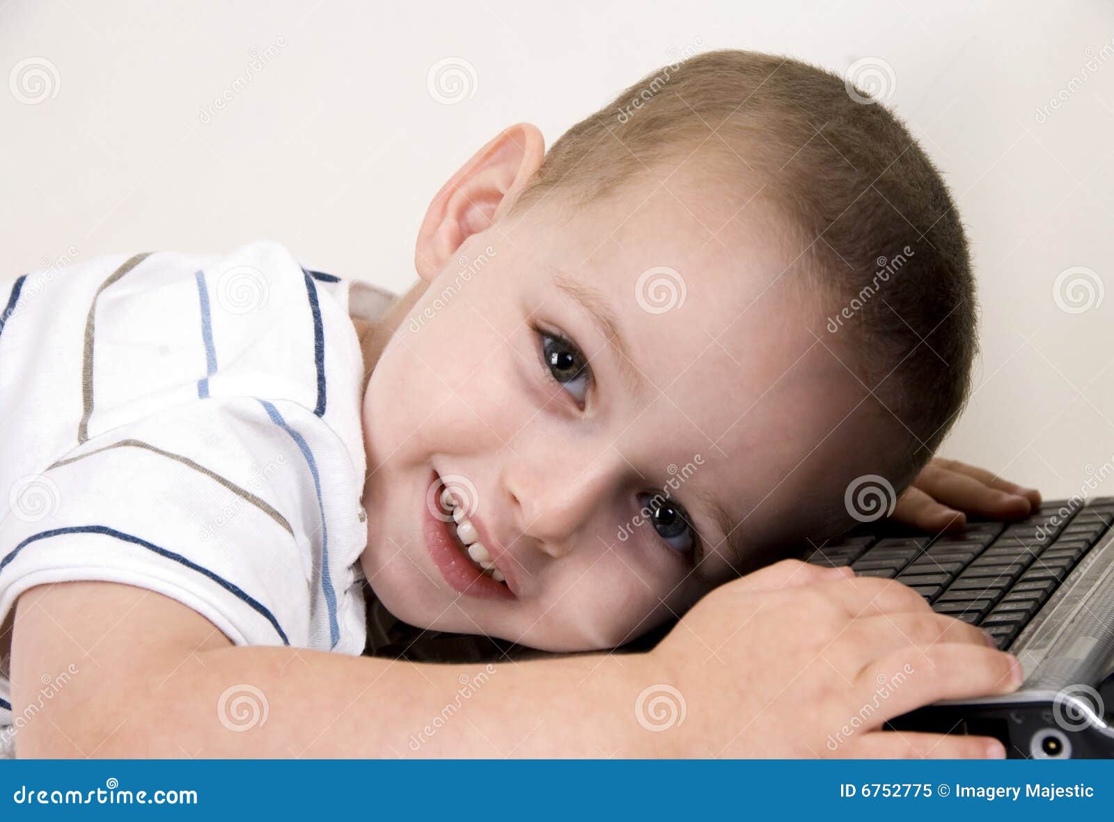Little boy lying on laptop stock image. Image of person - 6752775
