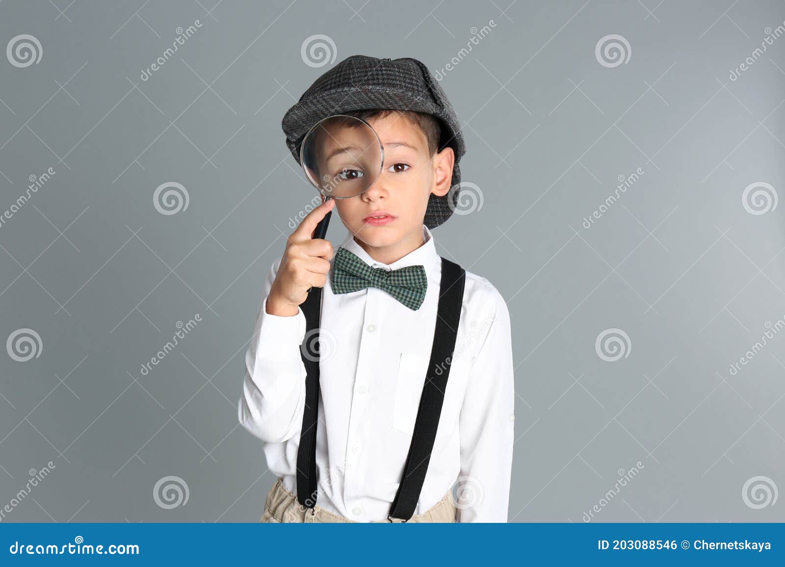 Little Boy with Magnifying Glass Playing Detective on Grey Background ...