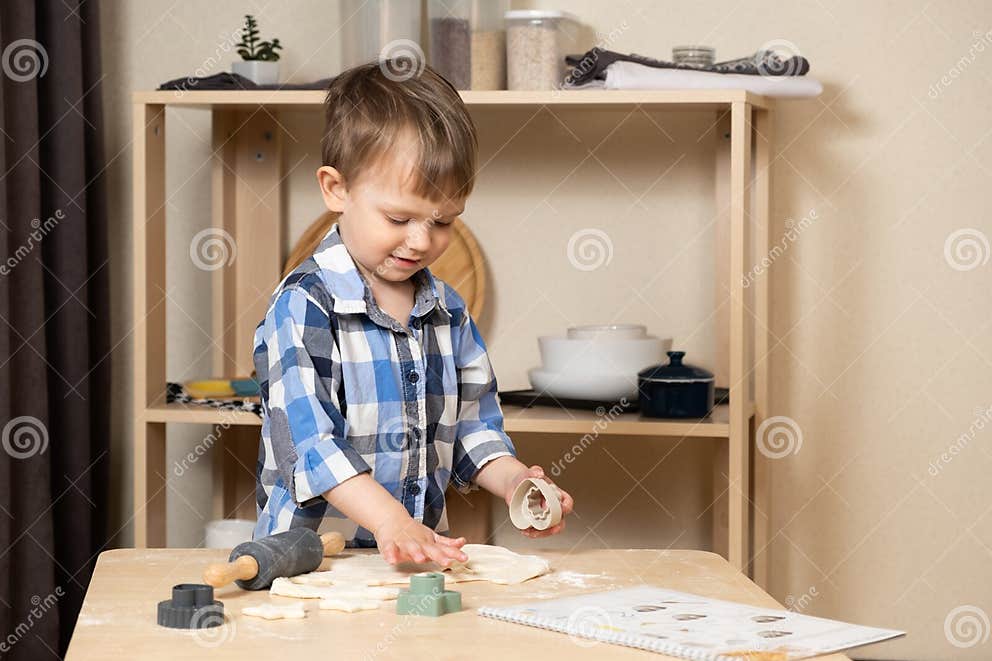 Little Boy Making Cookies Using Cookie Cutters and Dough in the Kitchen ...
