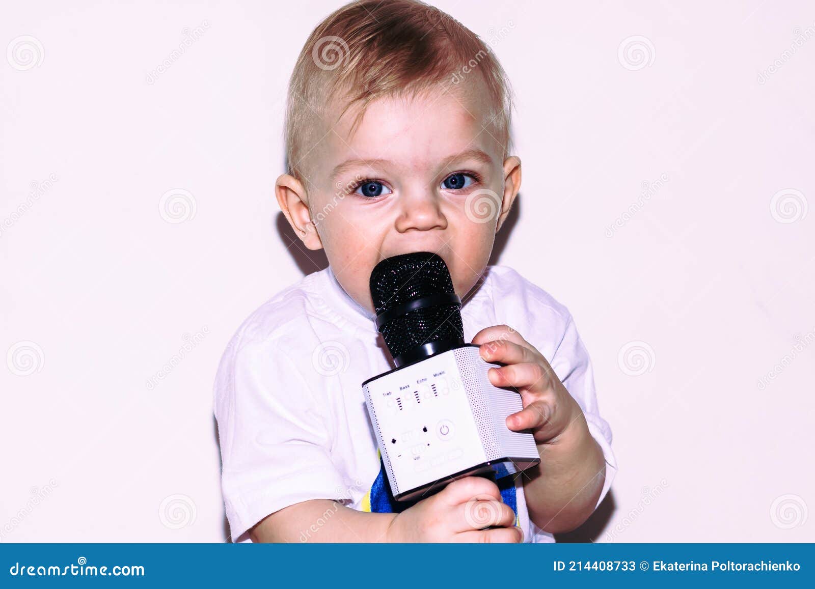 Little Boy of 9 Months Sits on the Floor with a Microphone. Stock Image ...