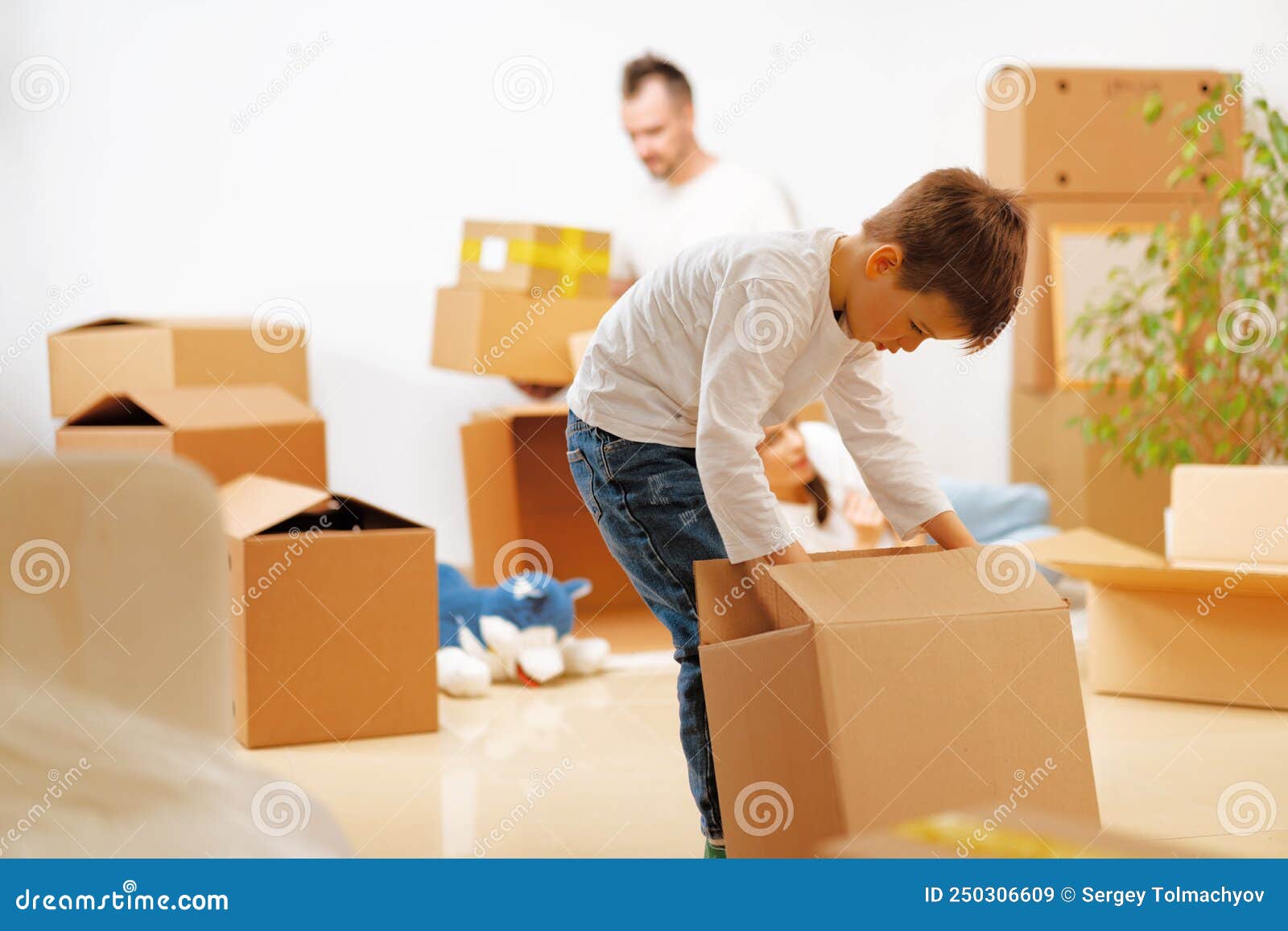 Little Boy Packing a Moving Box for a New Home Stock Image - Image of ...