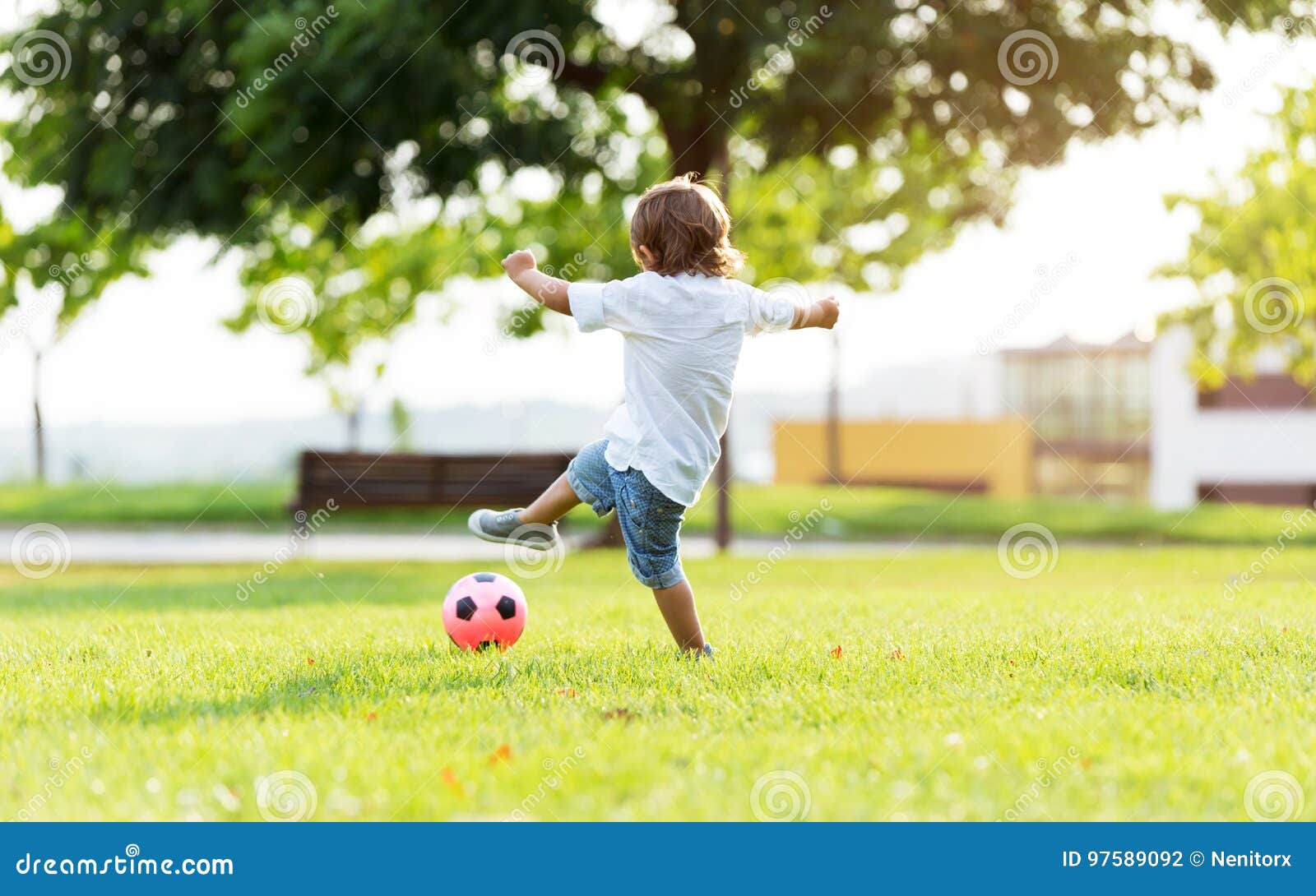 The Little Boy Playing with Ball in the Park. Stock Photo - Image of ...
