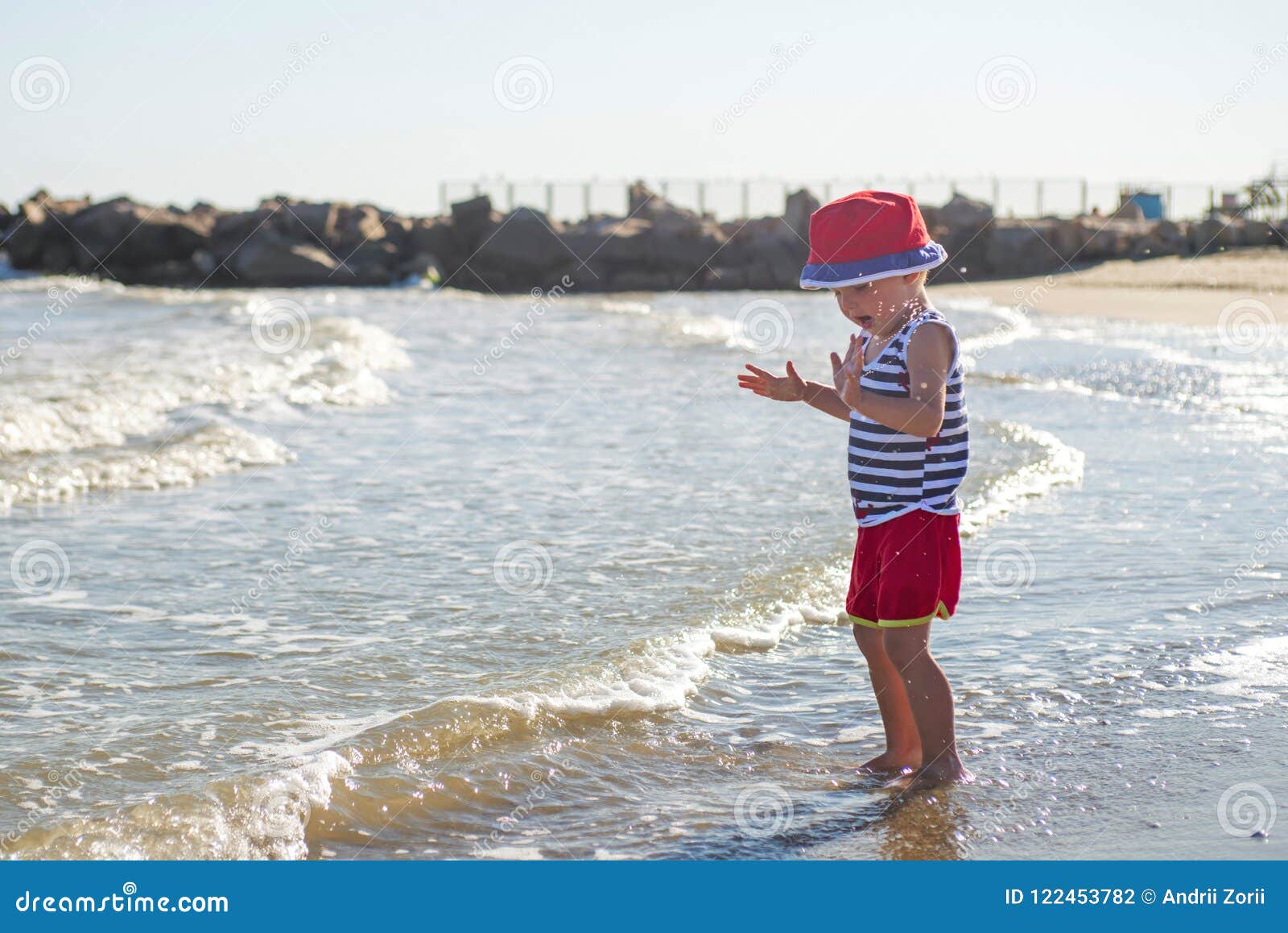 Little Boy Playing on the Beach. Stock Photo - Image of reflection ...