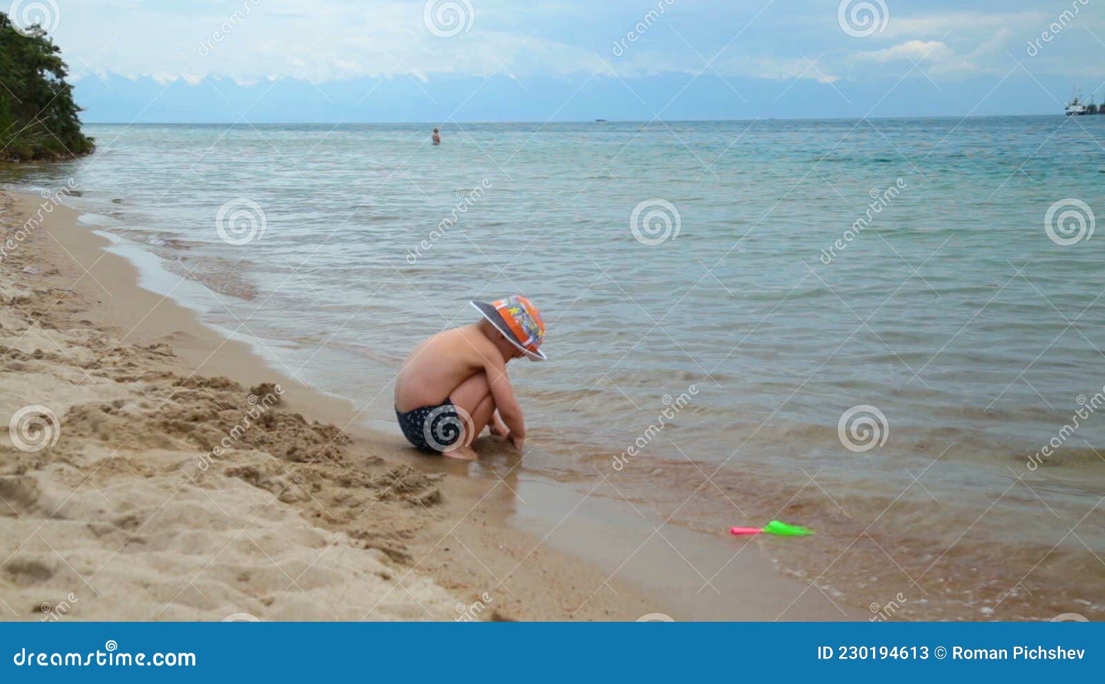Little Boy is Playing on the Beach in the Sand, by the Sea Stock Video ...