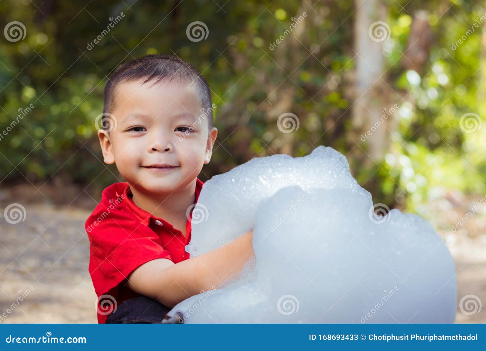 Little Boy Playing Blowing and Making Soap Bubbles Holding Bubble in ...