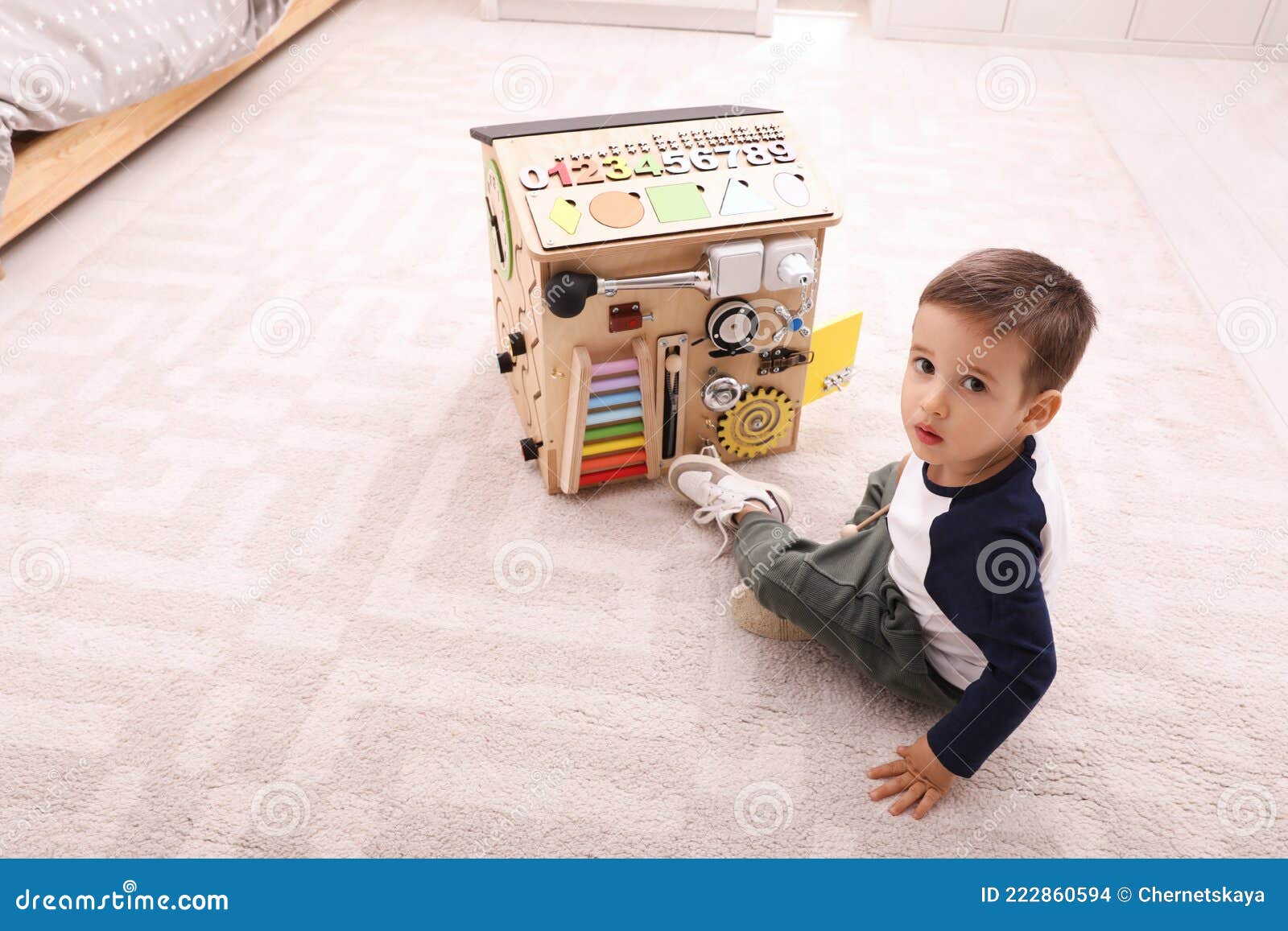 Little Boy Playing with Busy Board on Floor Stock Photo - Image of ...