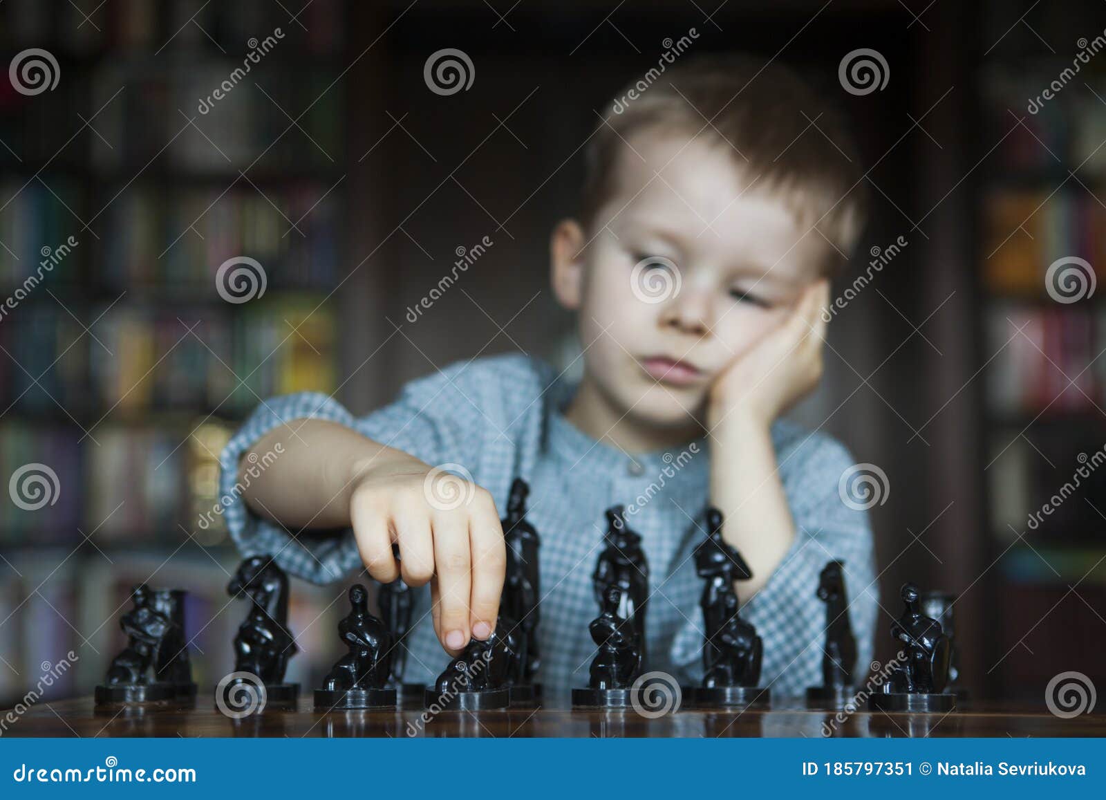 Little boy playing chess. stock image. Image of childhood - 185797351