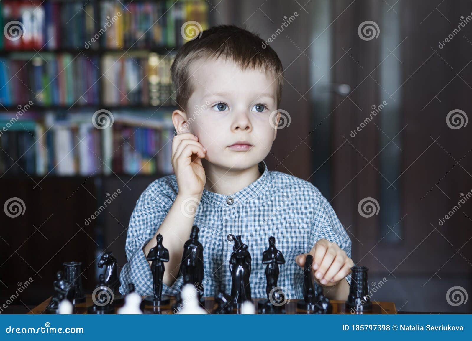 Little boy playing chess. stock photo. Image of plays - 185797398