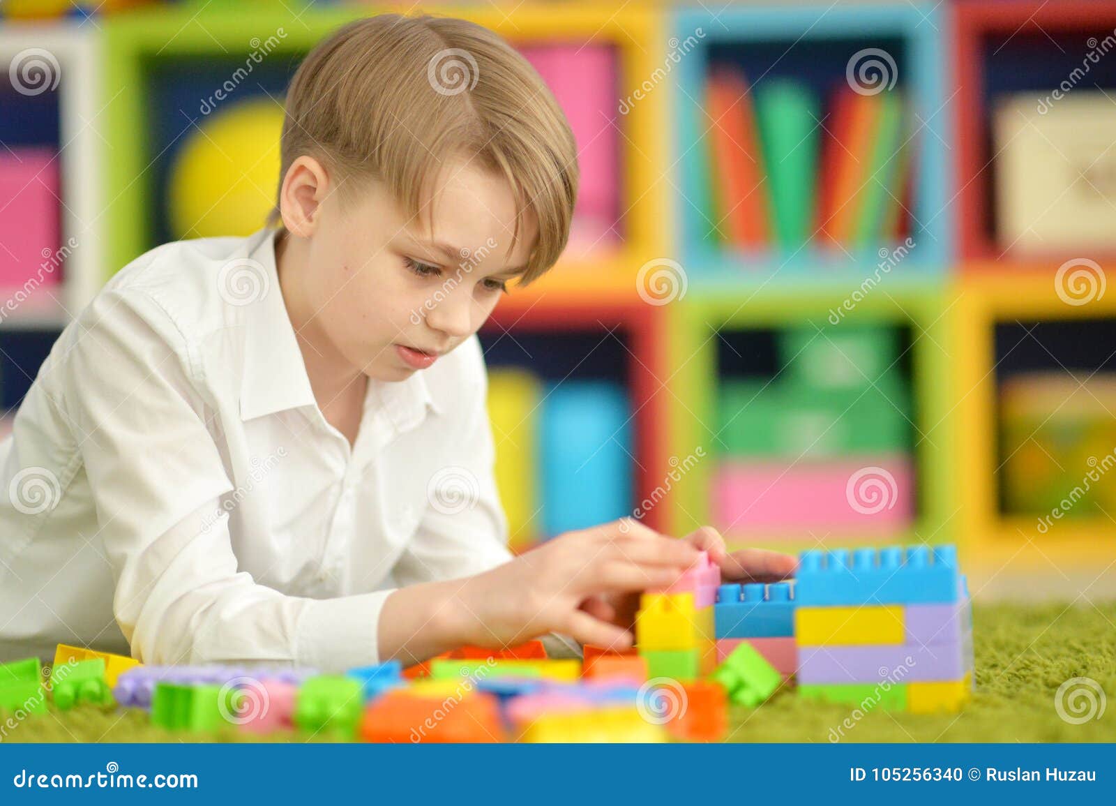 Boy playing with blocks stock photo. Image of background - 105256340