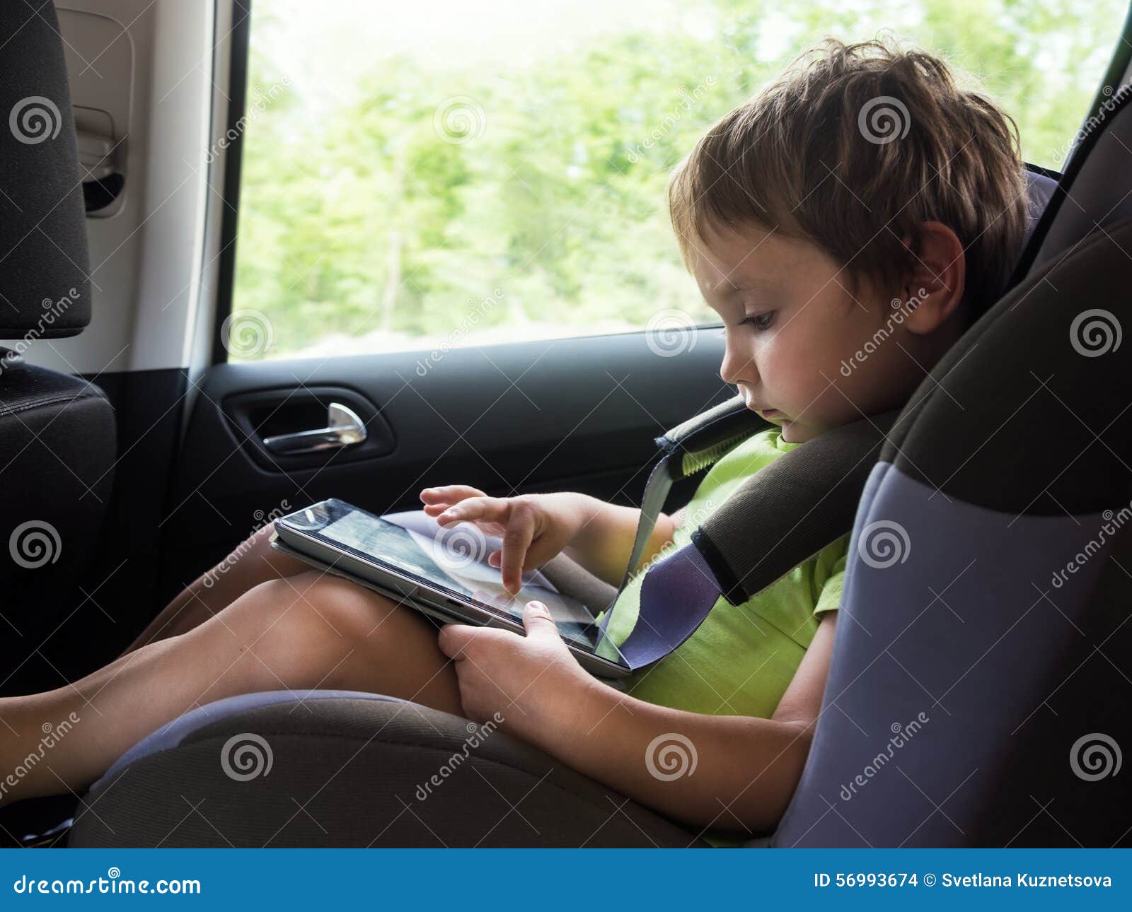 Little Boy Playing on Computer Tablet in the Car Stock Photo - Image of ...