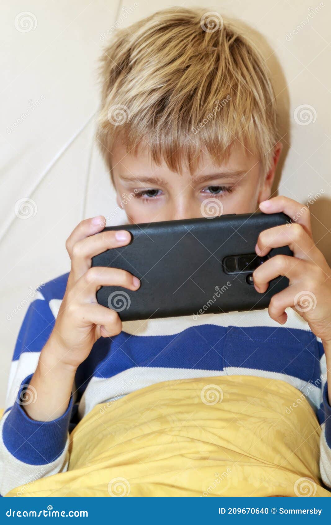 Little Boy Playing Game or Watching Something on Mobile Smart Phone ...