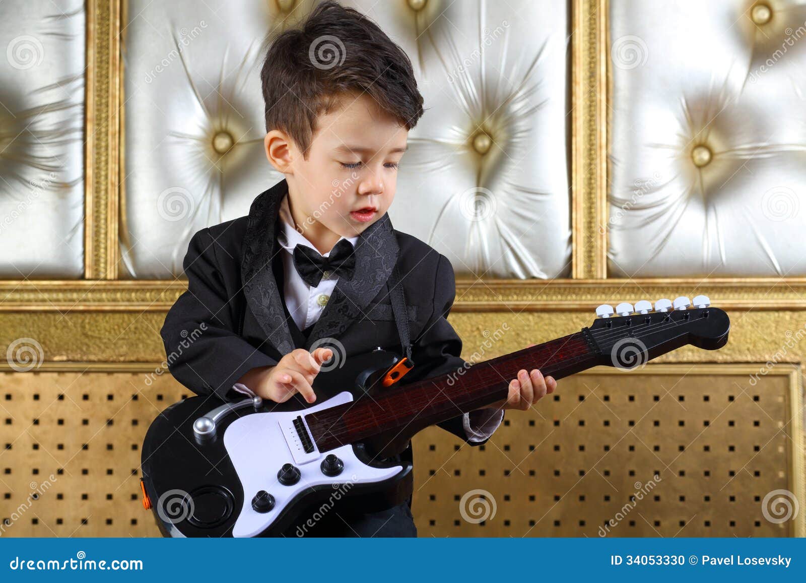 A Little Boy Playing Guitar Stock Photo - Image of indoors, nice: 34053330