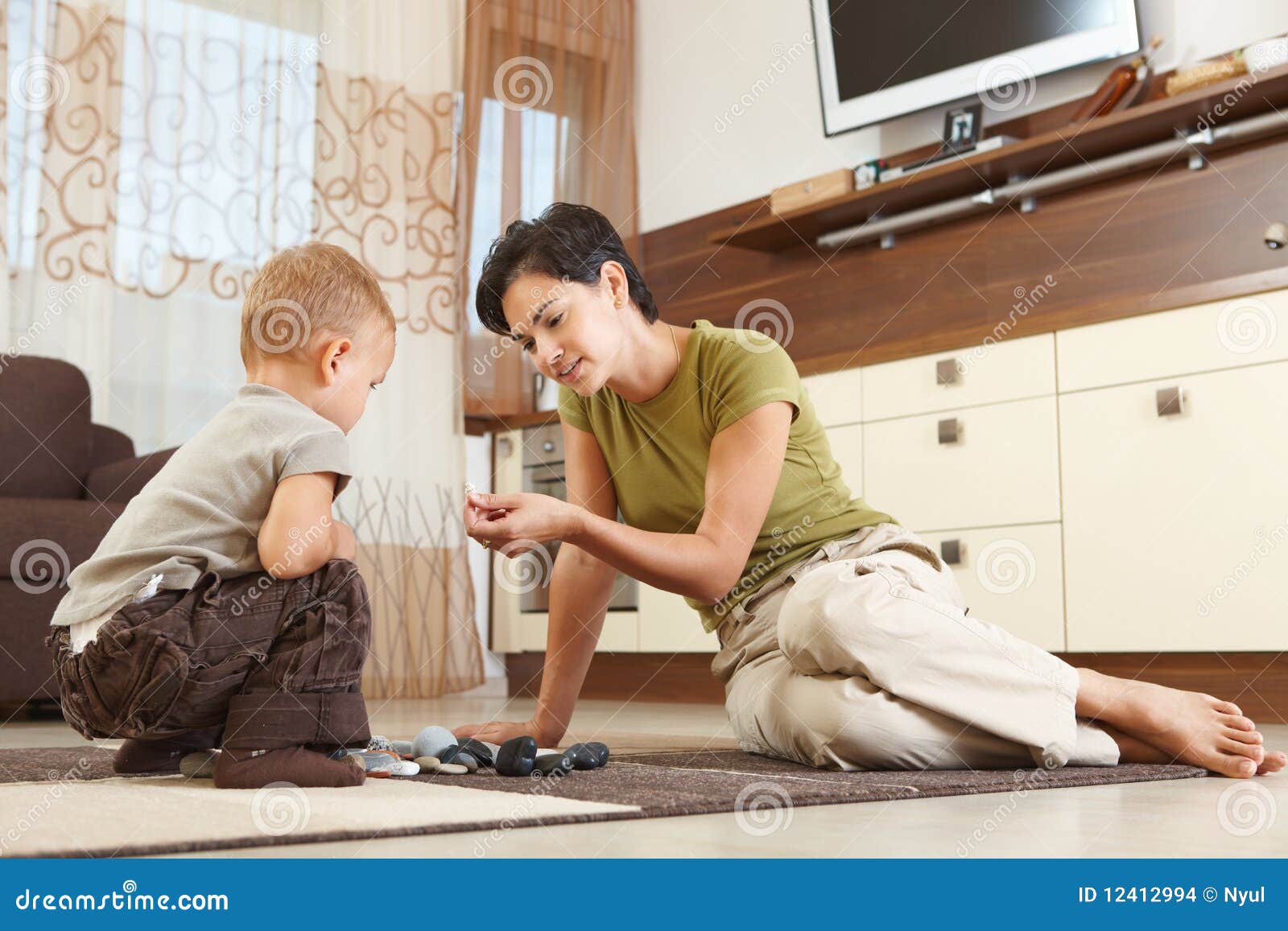 Little Boy Playing with Pebbles Stock Photo - Image of couch, interior ...