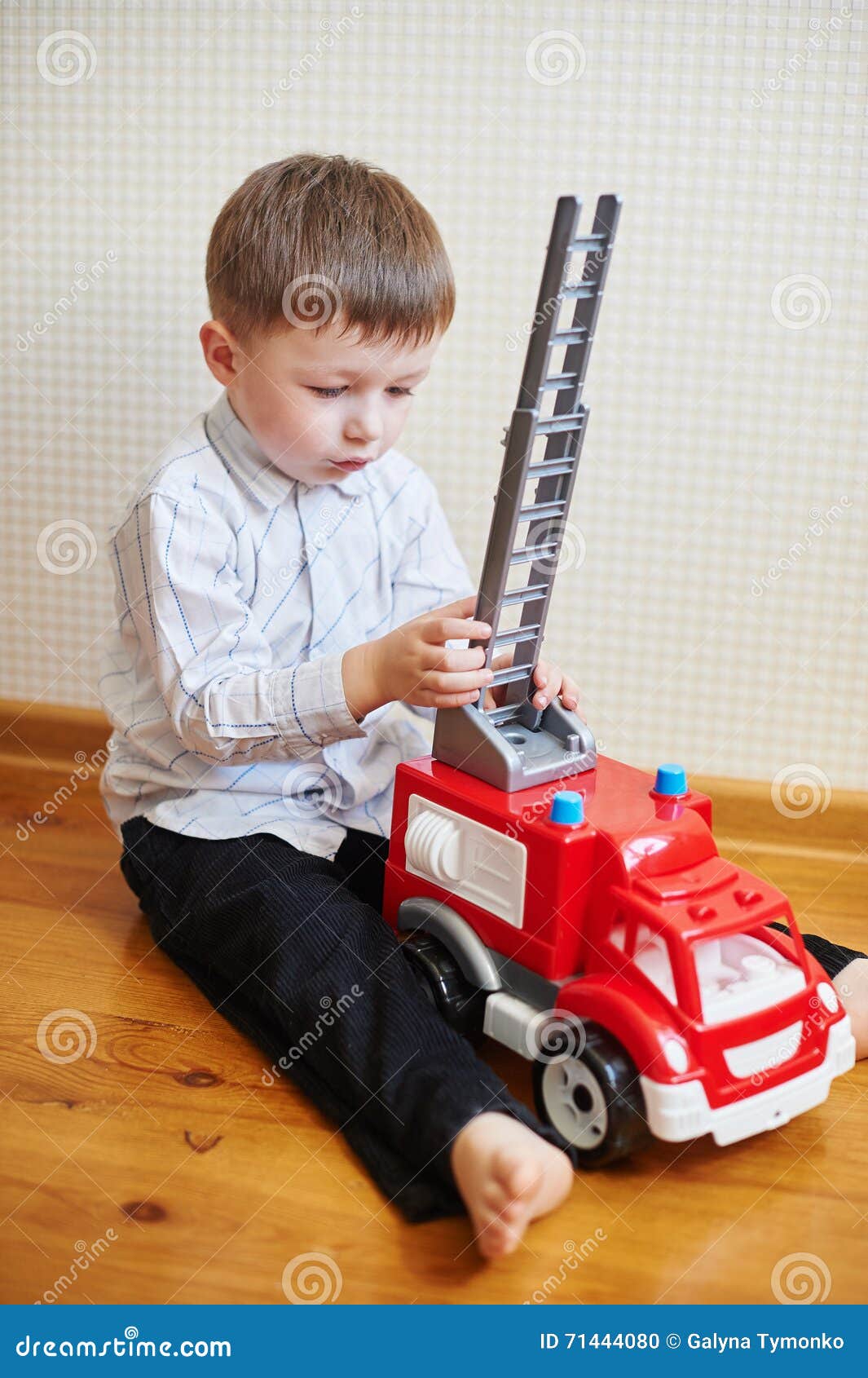 Little Boy Playing Red Toy Machine in Room Stock Photo - Image of ...