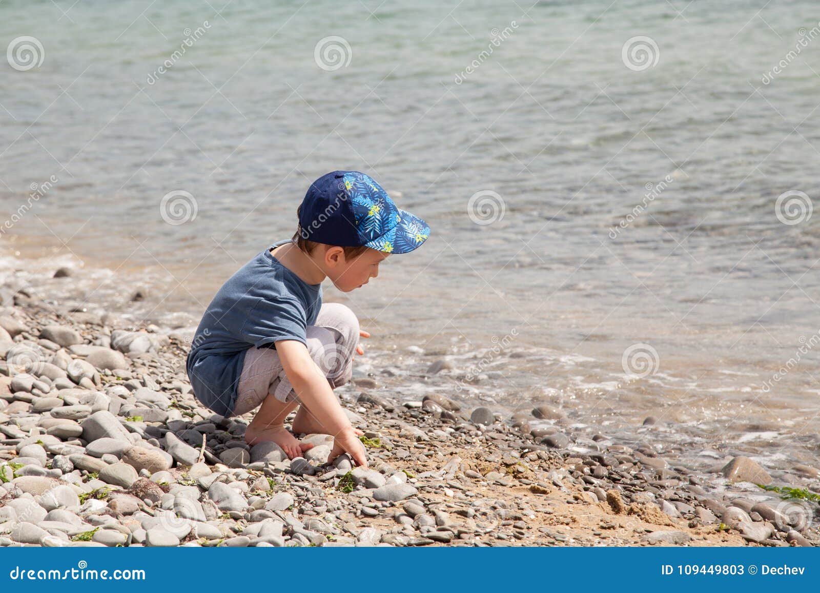 Little Boy Playing with Rocks on the Beach Stock Image - Image of ...