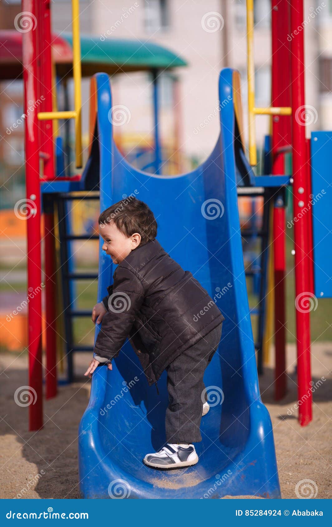 Little Boy Playing on Slide Stock Photo - Image of happiness, sitting ...