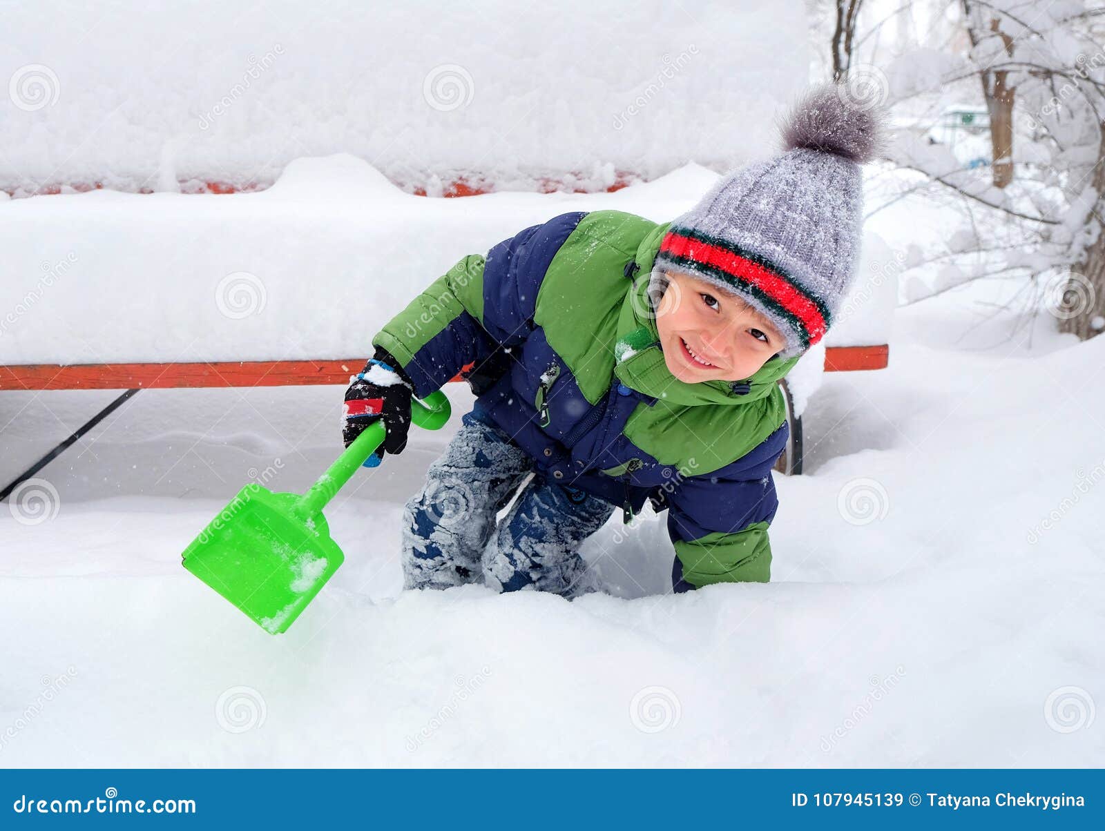 Little Boy Playing in the Snow on a Winter Day Stock Image - Image of ...