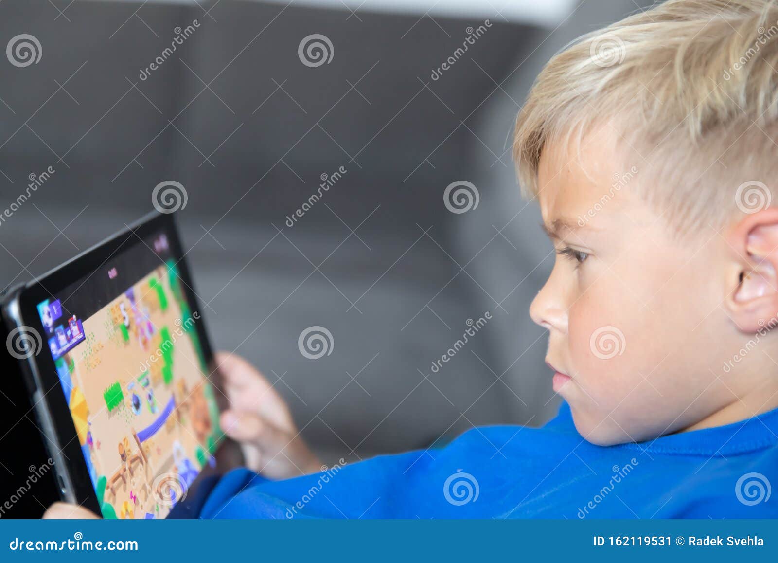 Little Boy Playing on Tablet Stock Image - Image of headphones ...