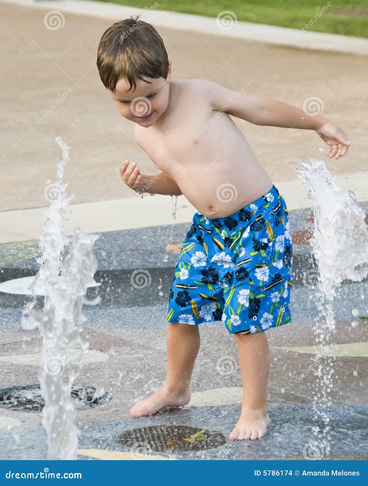 Little Boy Playing in a Water Fountain. Stock Photo - Image of water ...