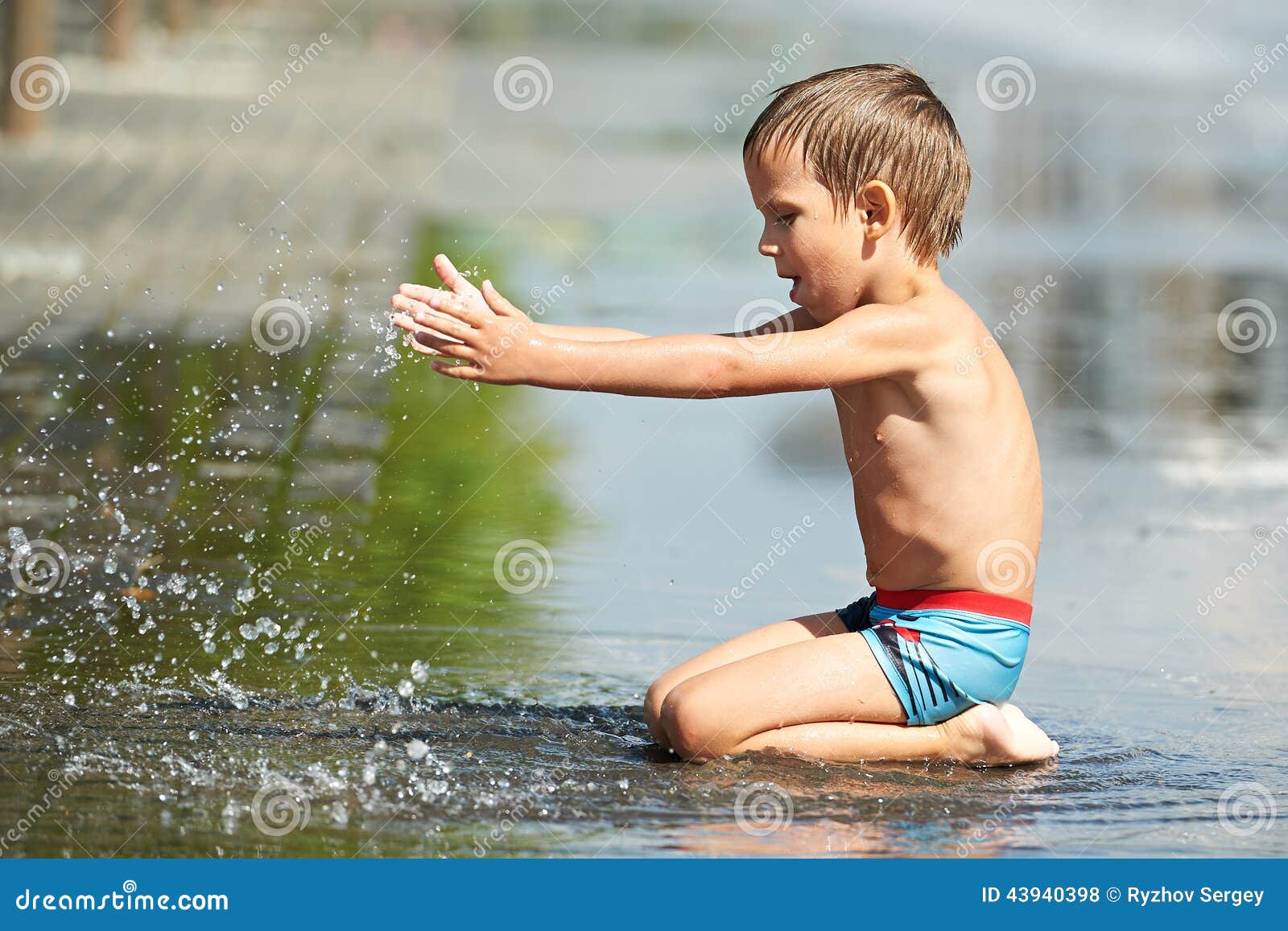 Little Boy Playing with Water in a Puddle Stock Photo - Image of cold ...