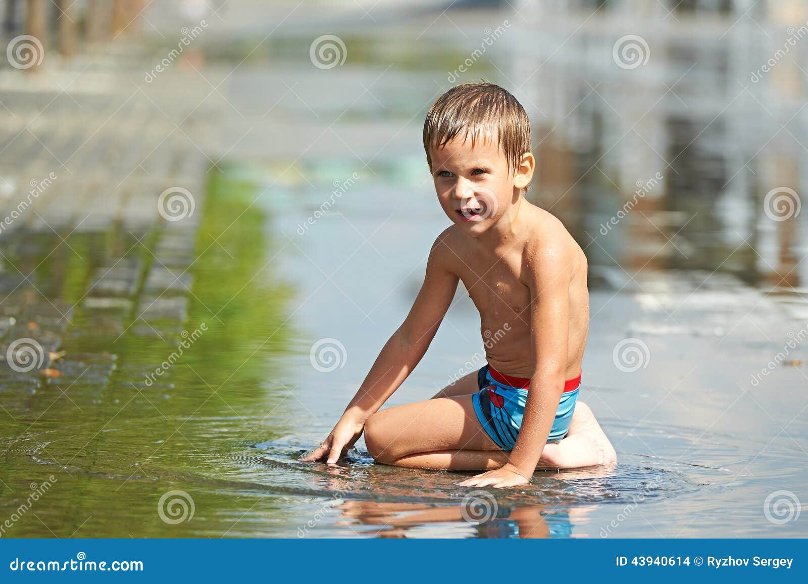 Little Boy Playing with Water in a Puddle Stock Photo - Image of ...