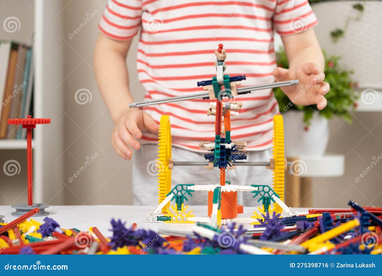 A Little Boy Plays with a Constructor, Creating Figures from Gears and ...