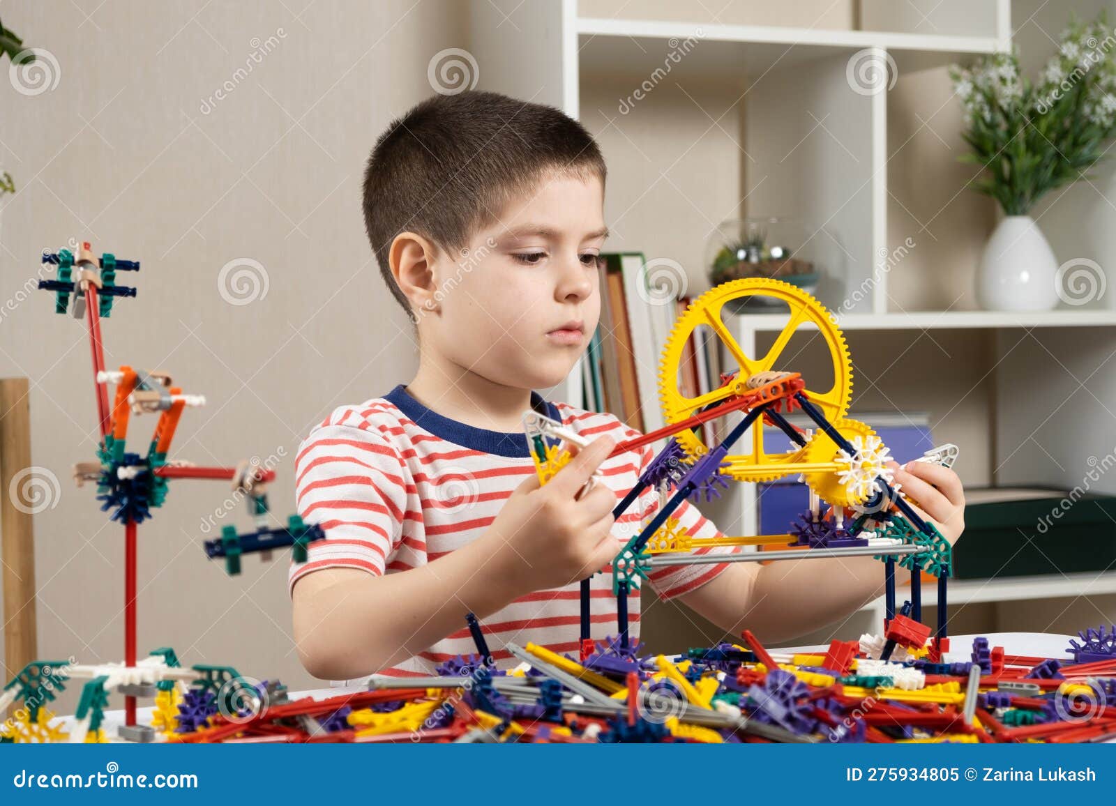 A Little Boy Plays with a Constructor, Creating Figures from Gears and ...