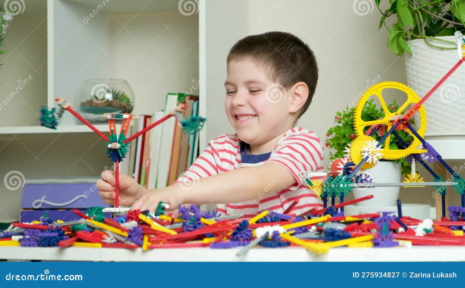 A Little Boy Plays with a Constructor, Creating Figures from Gears and ...