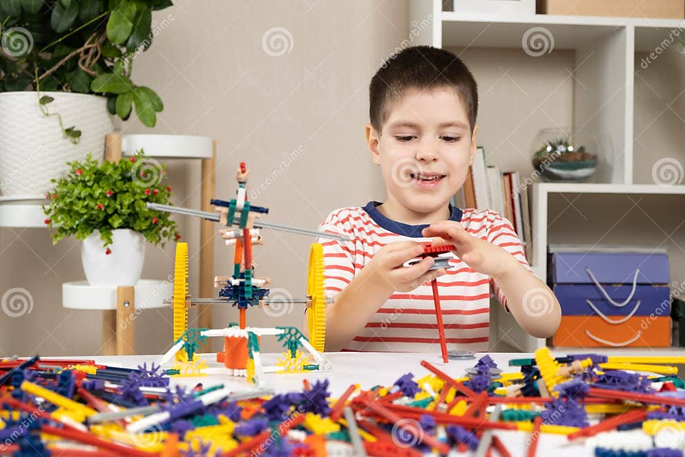 A Little Boy Plays with a Constructor, Creating Figures from Gears and ...
