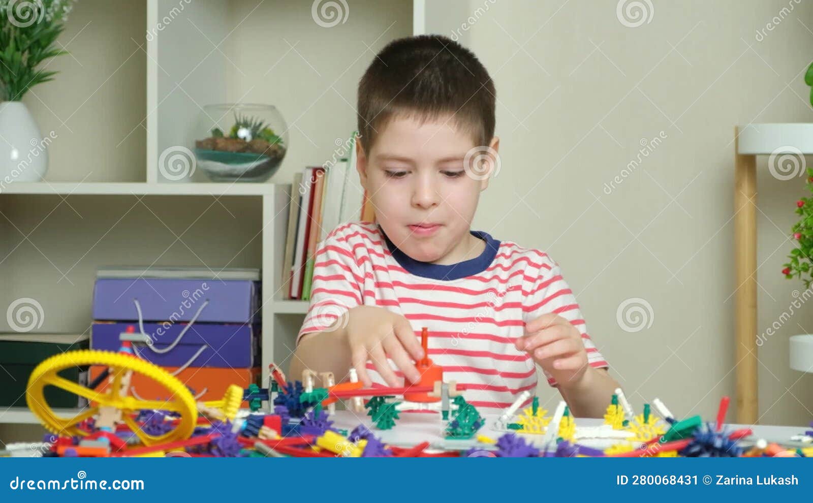 A Little Boy Plays with a Constructor, Creating Figures from Gears and ...