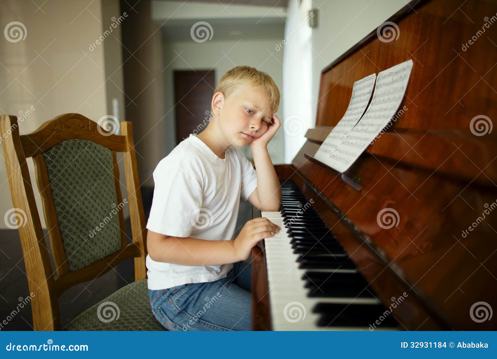 Little boy plays piano stock photo. Image of looking - 32931184