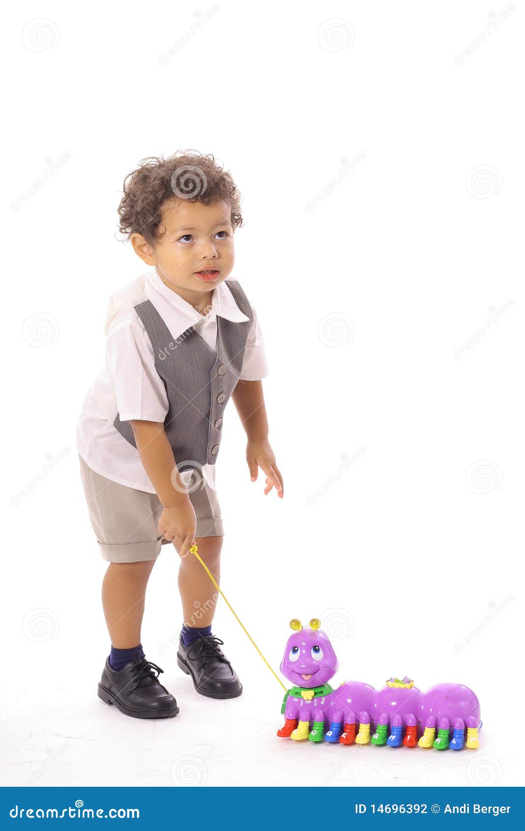 Little boy pulling his toy stock photo. Image of close - 14696392