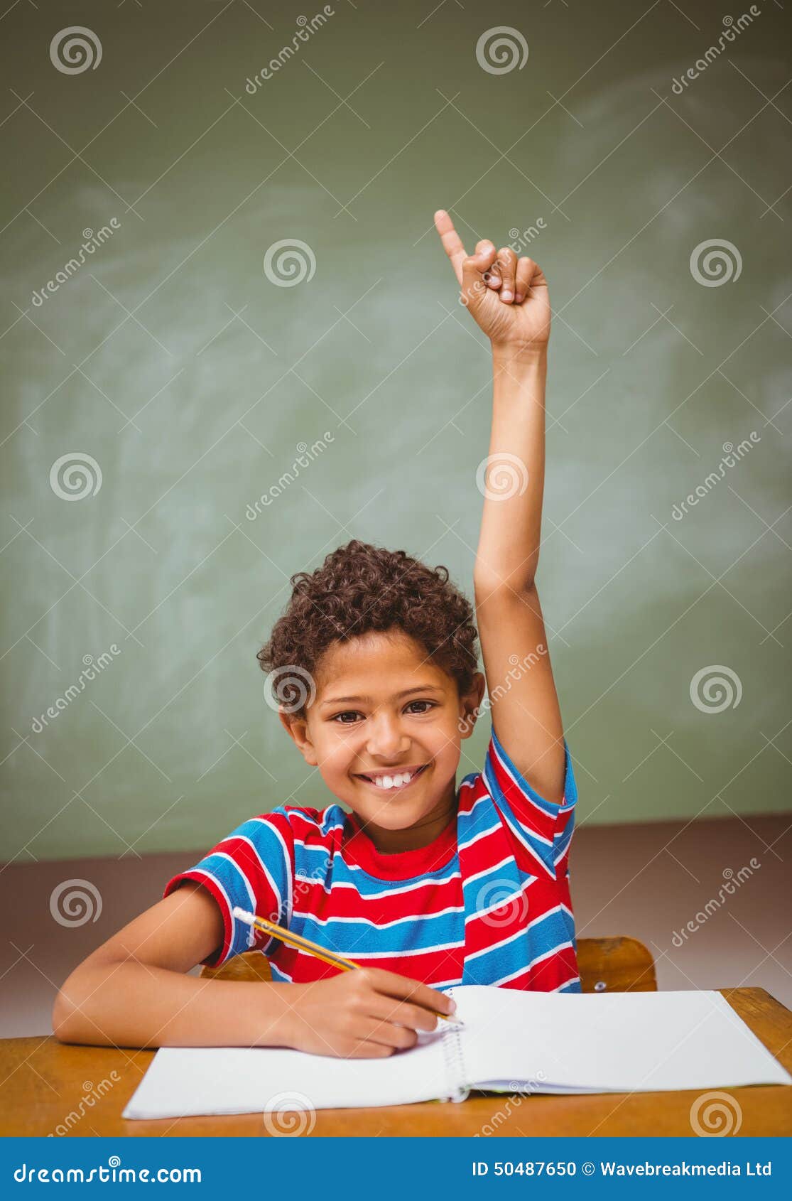 Little Boy Raising Hand in Classroom Stock Photo - Image of child ...