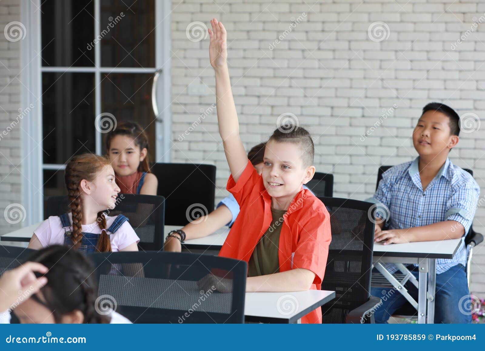 Little Boy Raising Hands in Classroom Education Concept Stock Image ...
