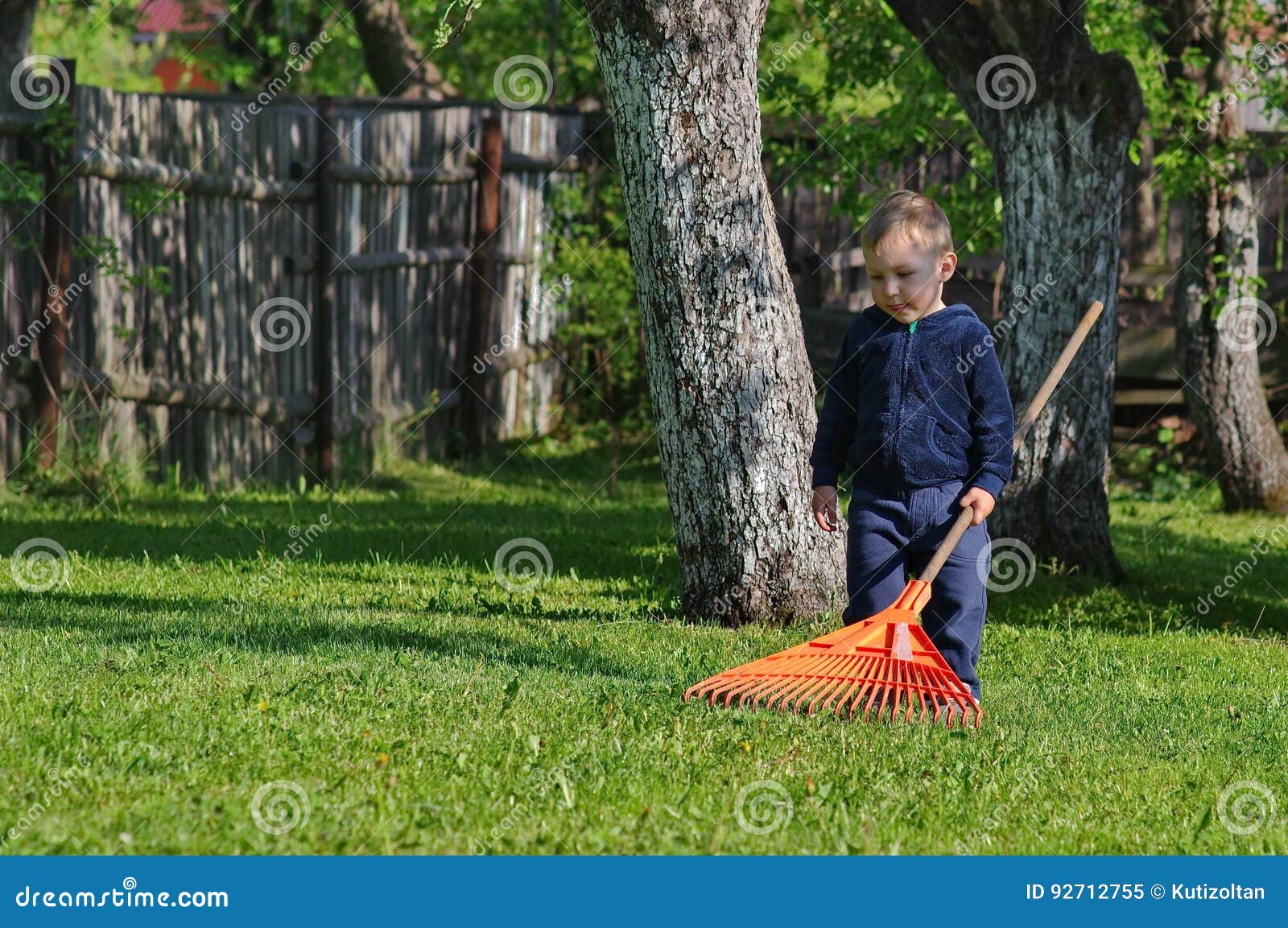 Little boy and the rake stock image. Image of eyes, flower - 92712755