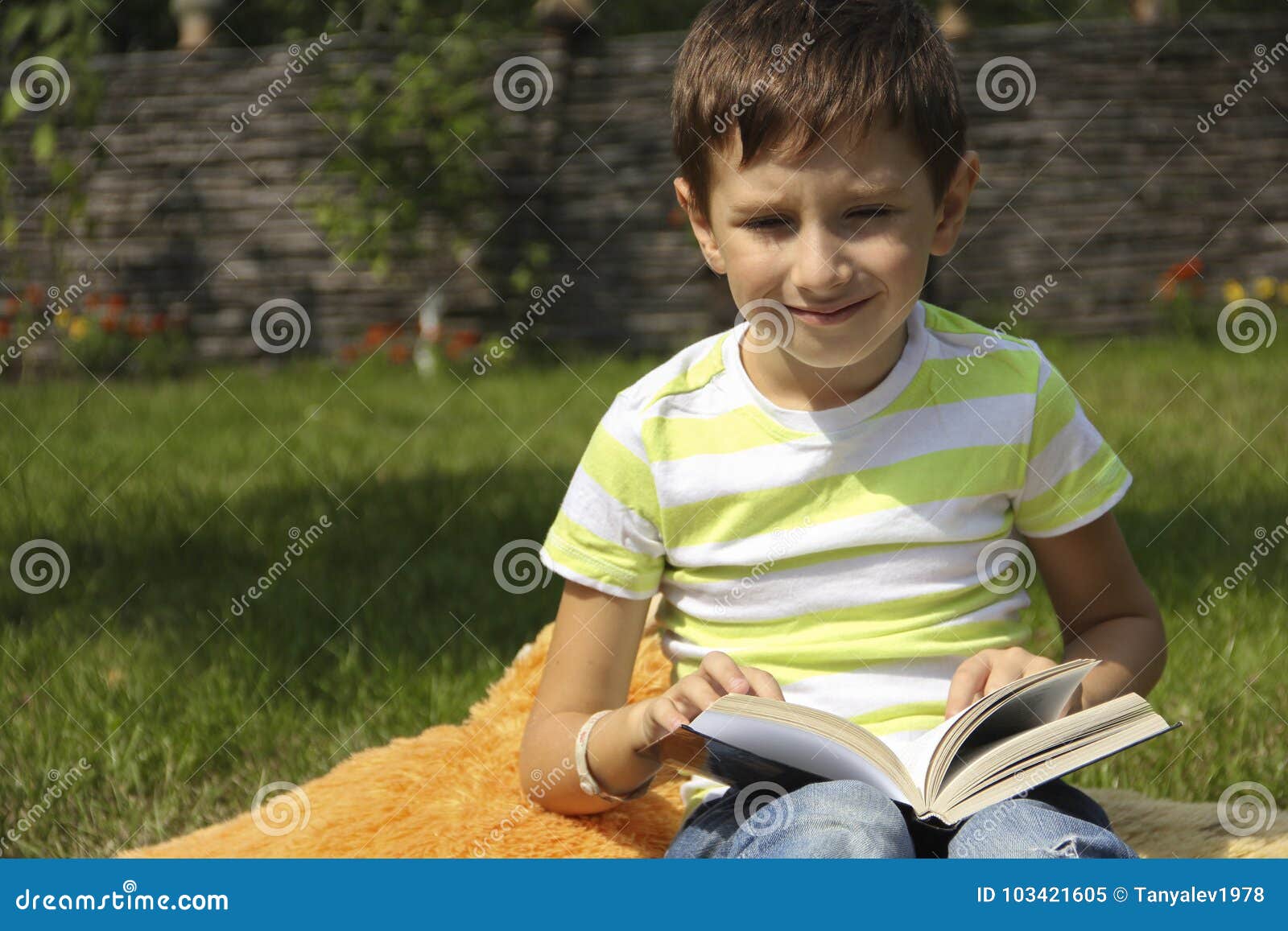 Little Boy is Reading a Book on the Grass Stock Image - Image of ...