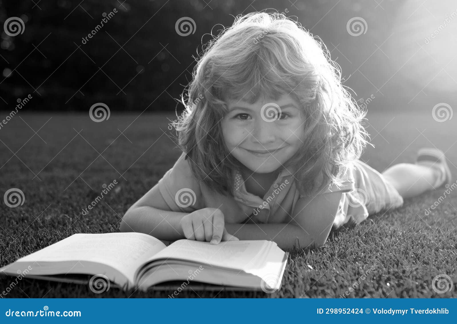 Little Boy Reading a Book in Summer Sunset Light. Stock Photo - Image ...
